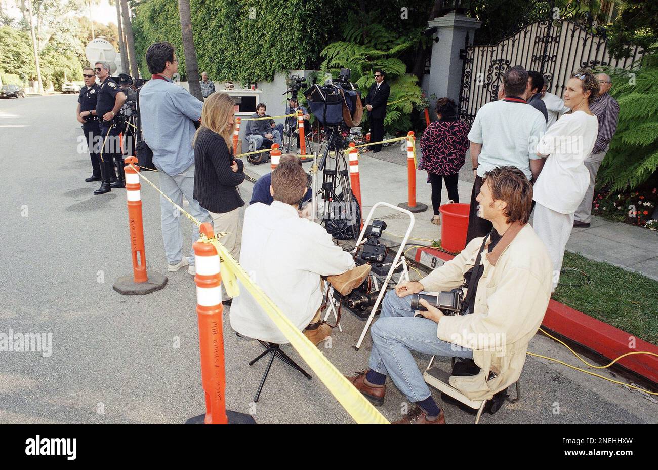 Members of the media from around the world gather outside the home of ...