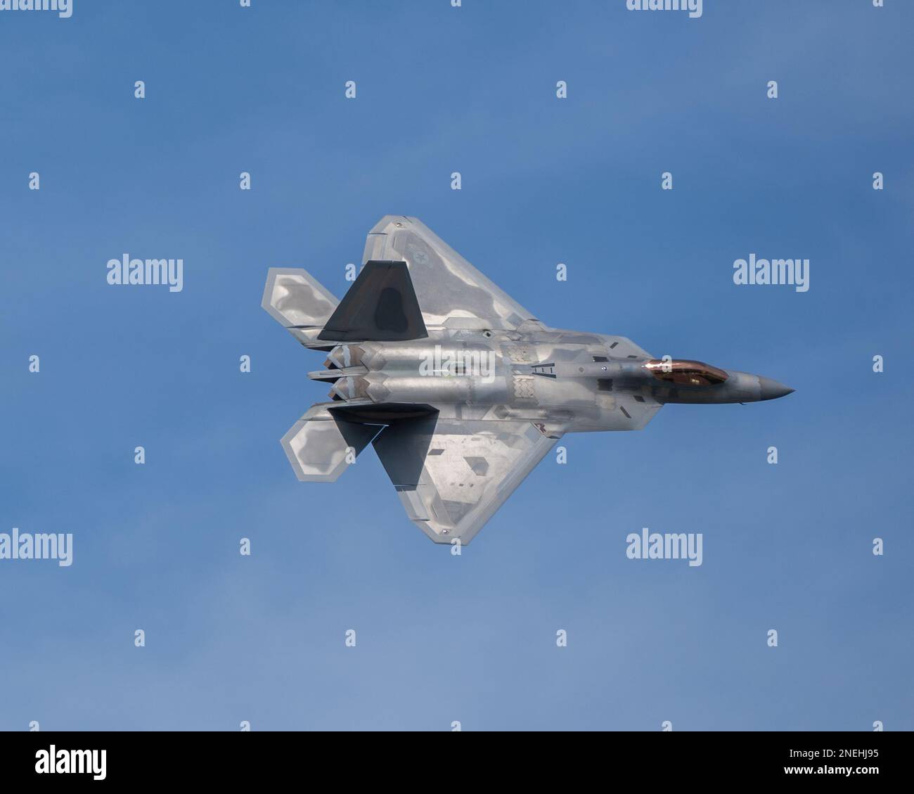 A F-22 Raptor shows off its skills in an aerial acrobatic demonstration ...