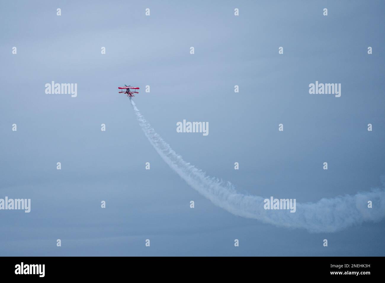 An acrobatic Aviation team flying close while performing stunts in red ...