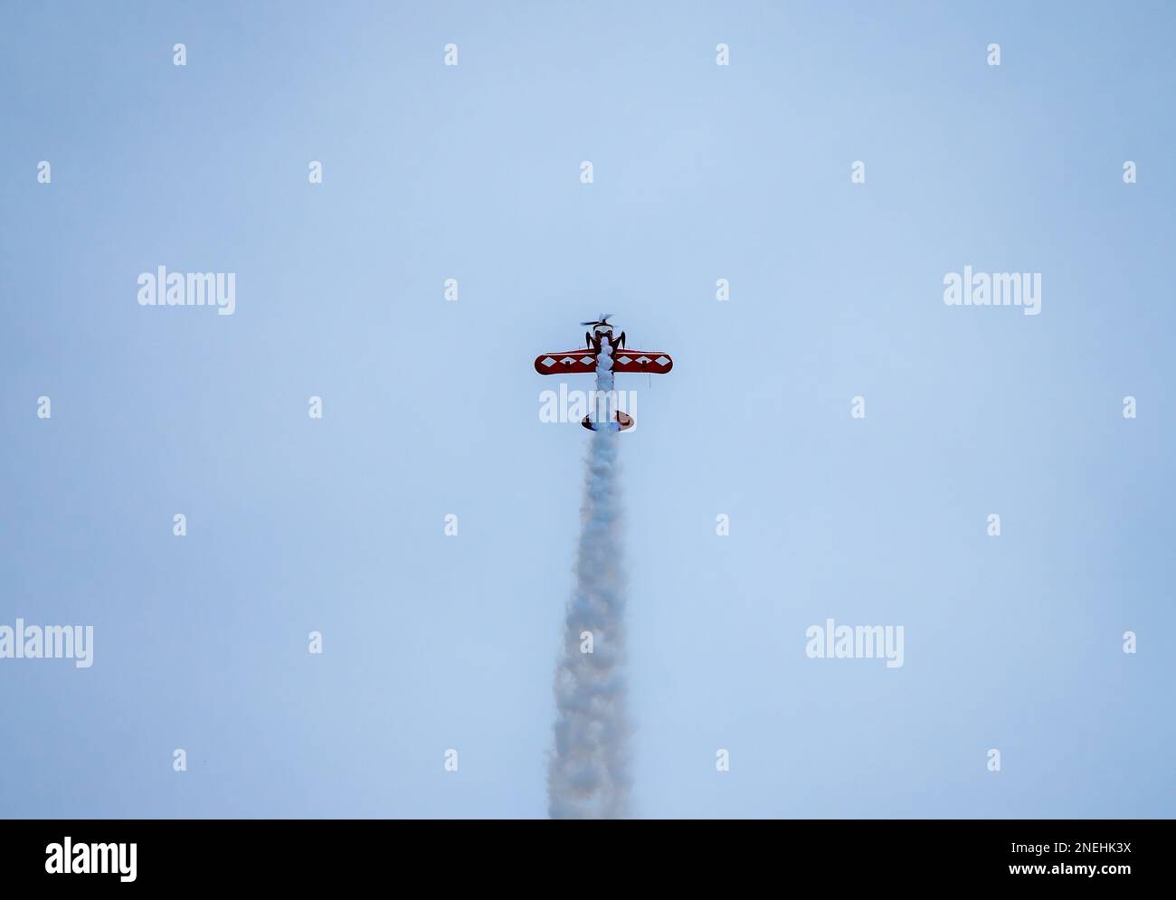 An acrobatic Aviation team flying close while performing stunts in red ...