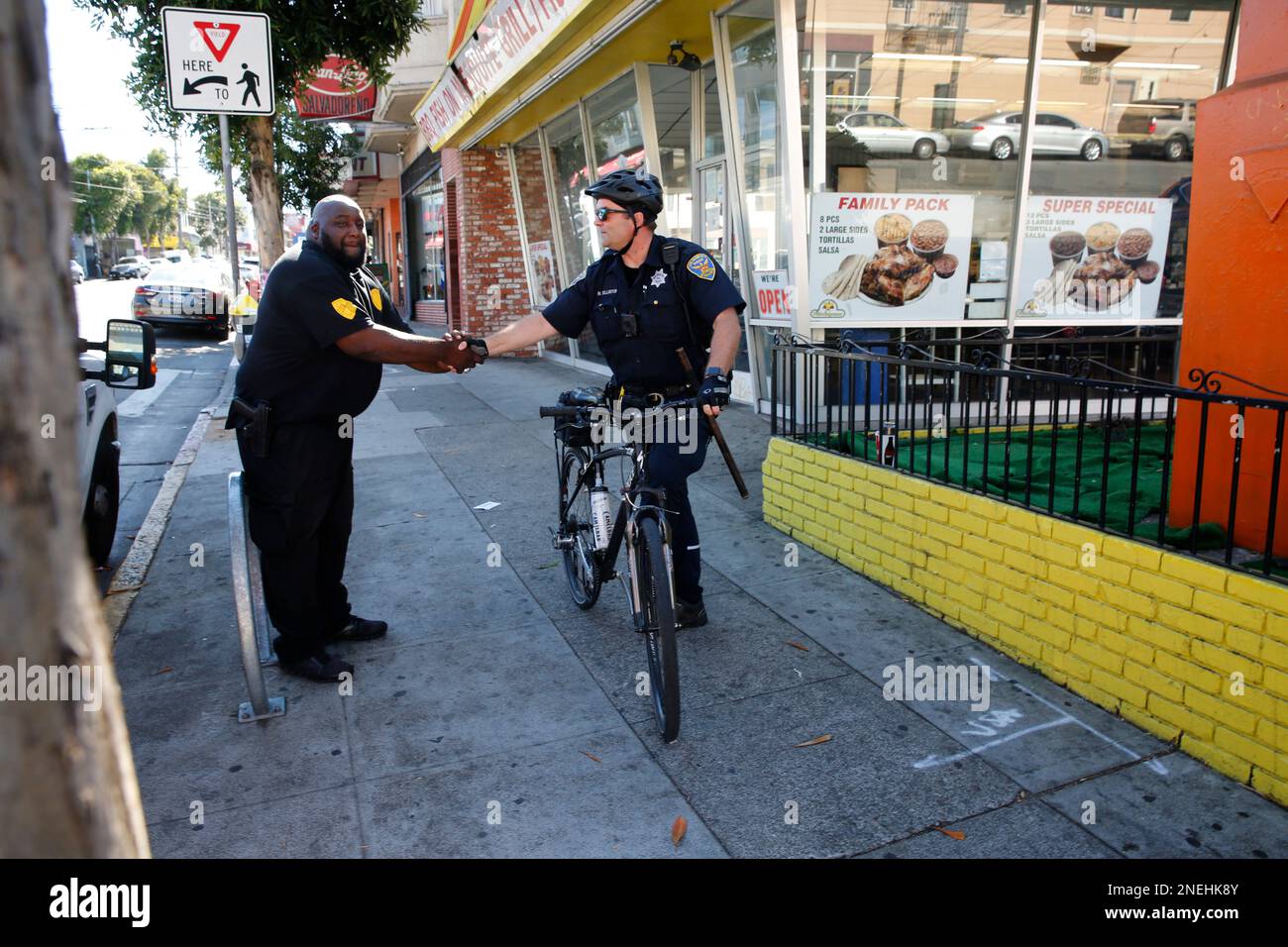 Vic Perkins, (left) a private security guard greets Officer Mike ...