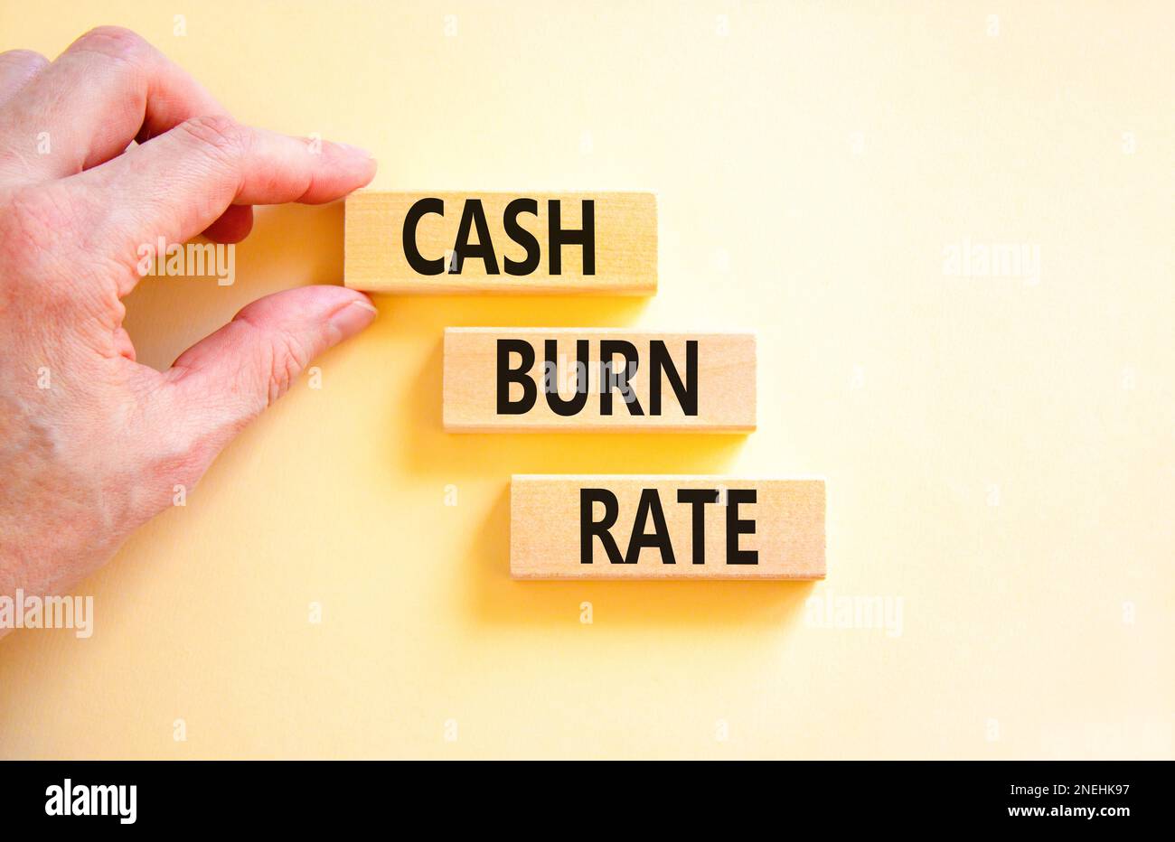 Cash burn rate symbol. Concept words Cash burn rate on wooden blocks on ...