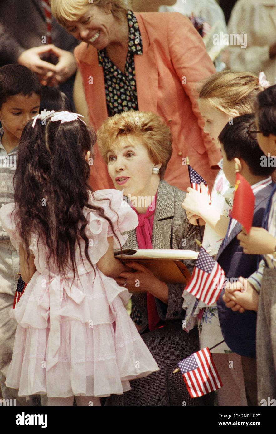 Soviet First Lady Raisa Gorbachev kneels down Friday to speak with ...