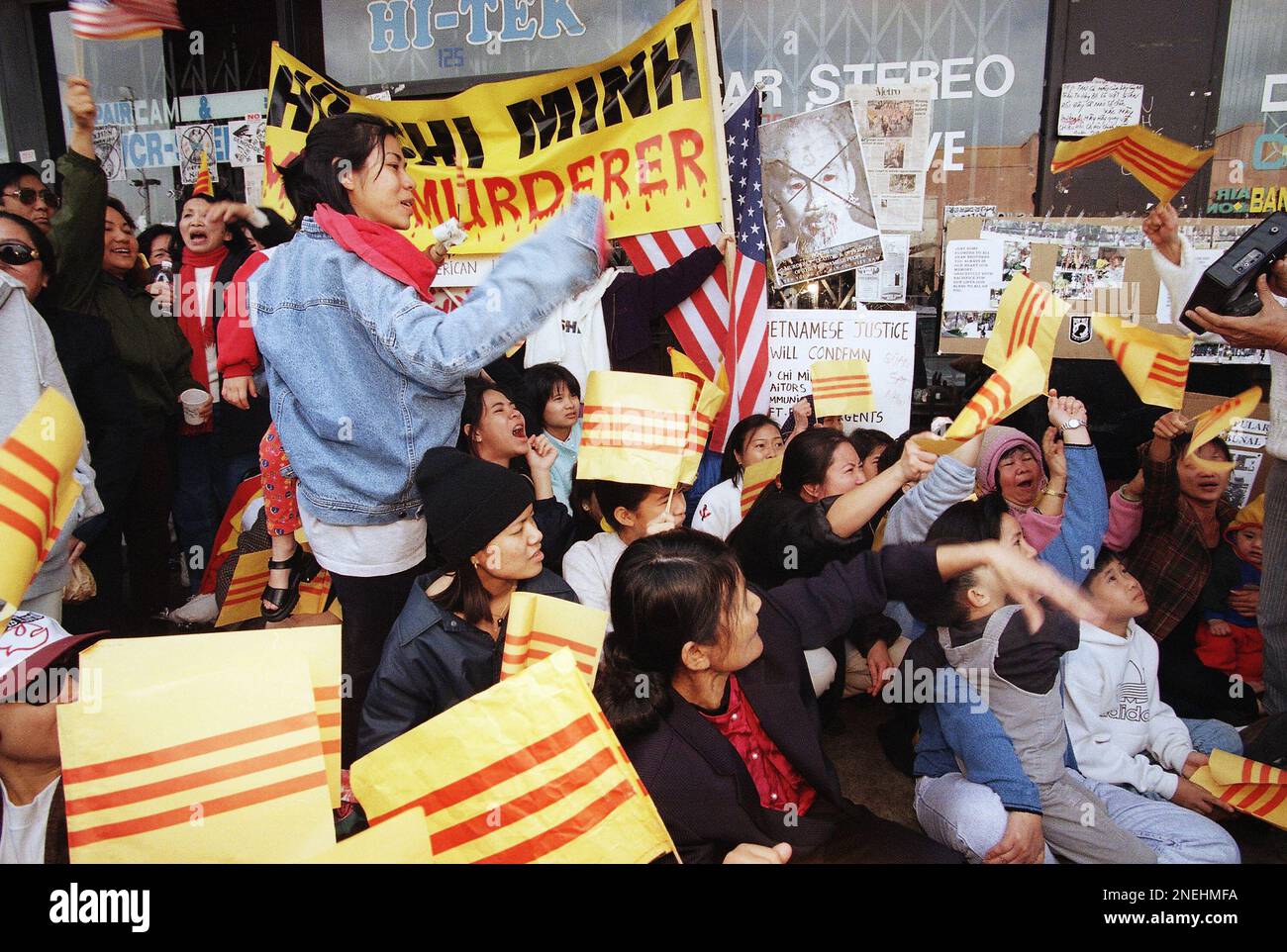 Protesters Hold Up Signs And South Vietnamese Flags Outside The Hi Tek