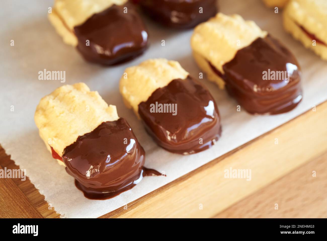 Baked Christmas cookies dipped in chocolate icing Stock Photo - Alamy