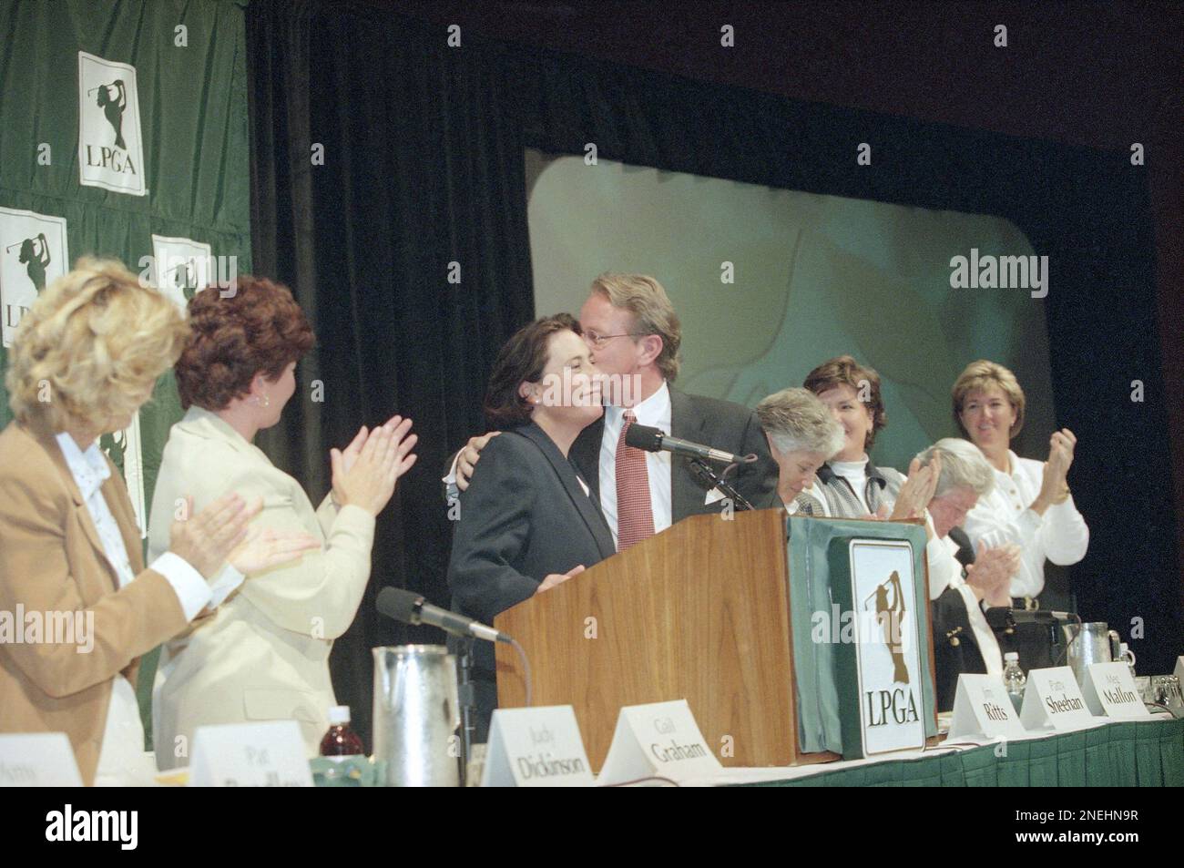 Golfer Amy Alcott gets a kiss from LPGA commissioner Jim Ritts at a ...
