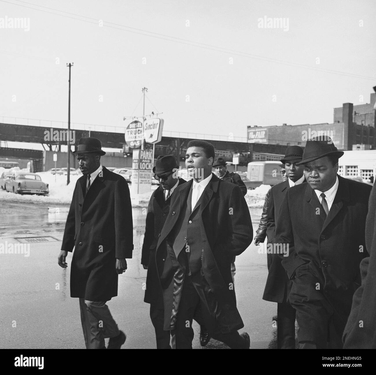 Muhammad Ali (Cassius Clay), hatless and mouth open, walks to ...