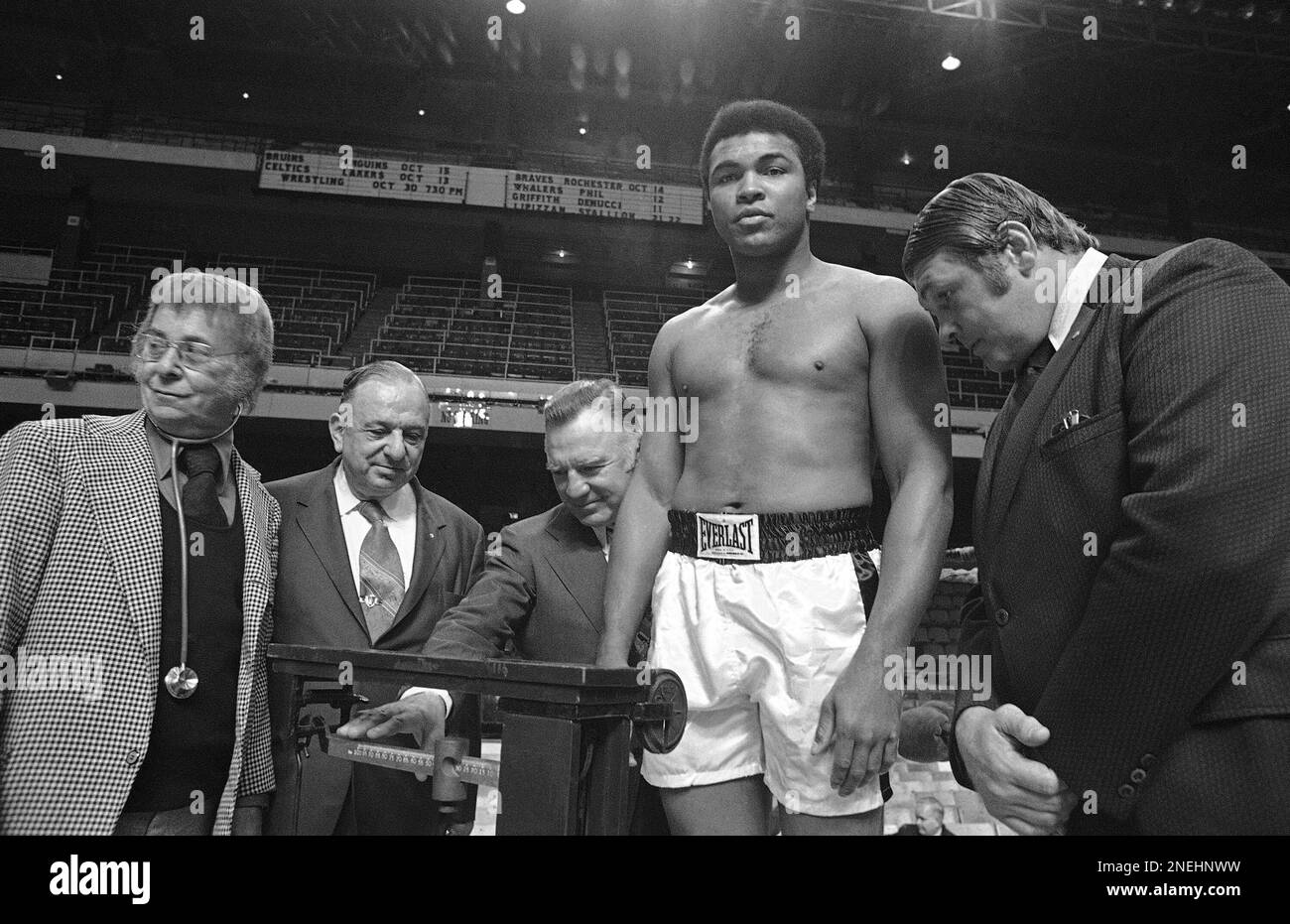 Former heavyweight champion Muhammad Ali stands on the scales during ...