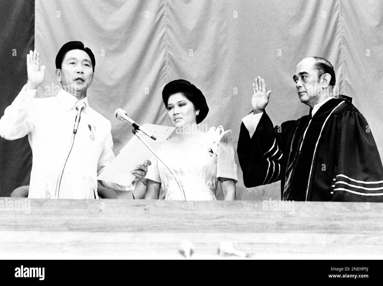 President Ferdinand E. Marcos (left) is administered the oath of office ...