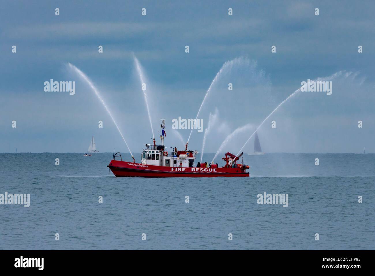A Red Fire boat with Active Water Canons Stock Photo - Alamy