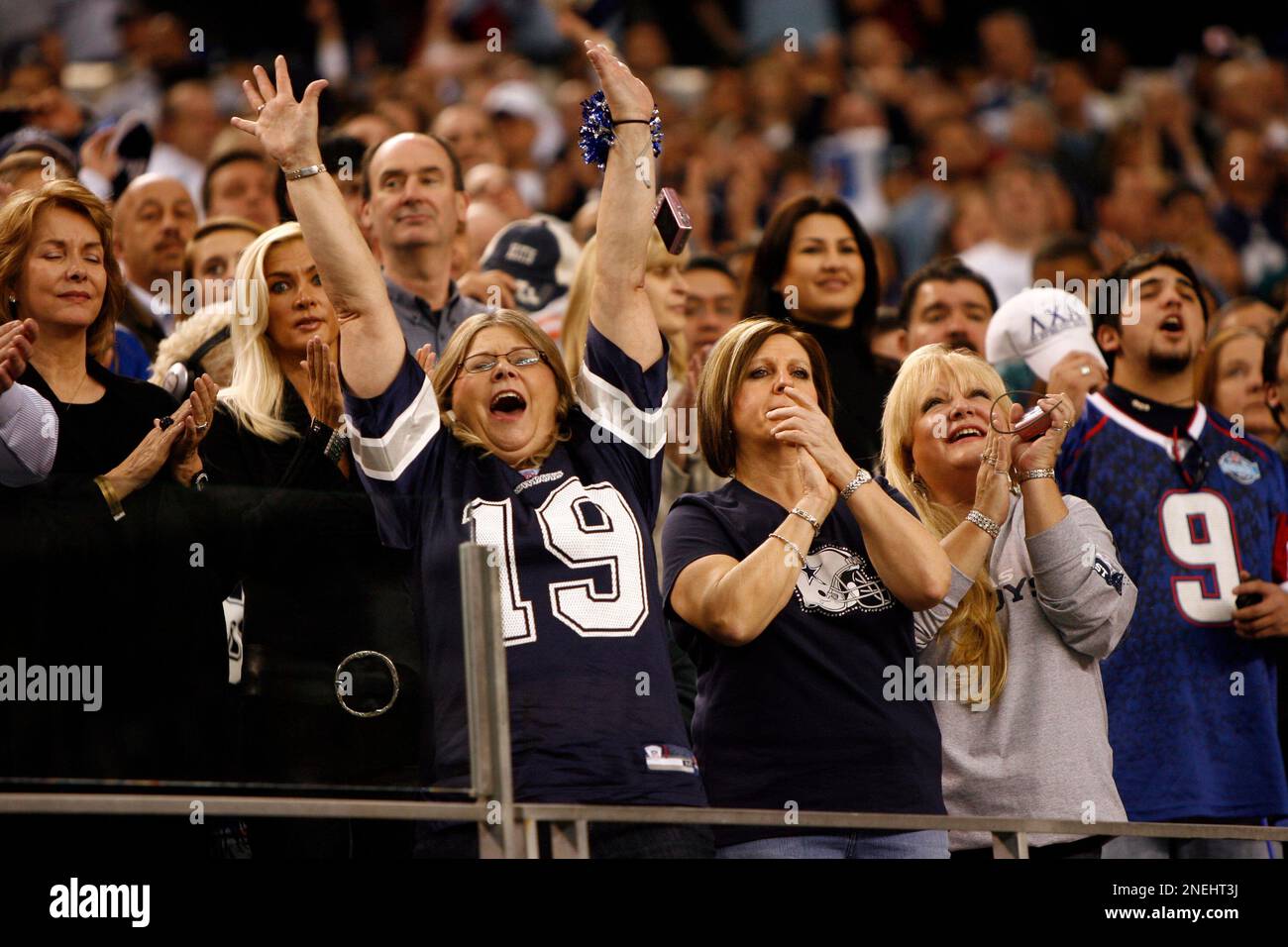Football fans cheer after they sing the National Anthem before an NFL ...