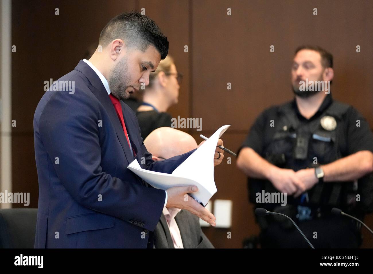 Defense attorney George Gomez looks over a document during an ...