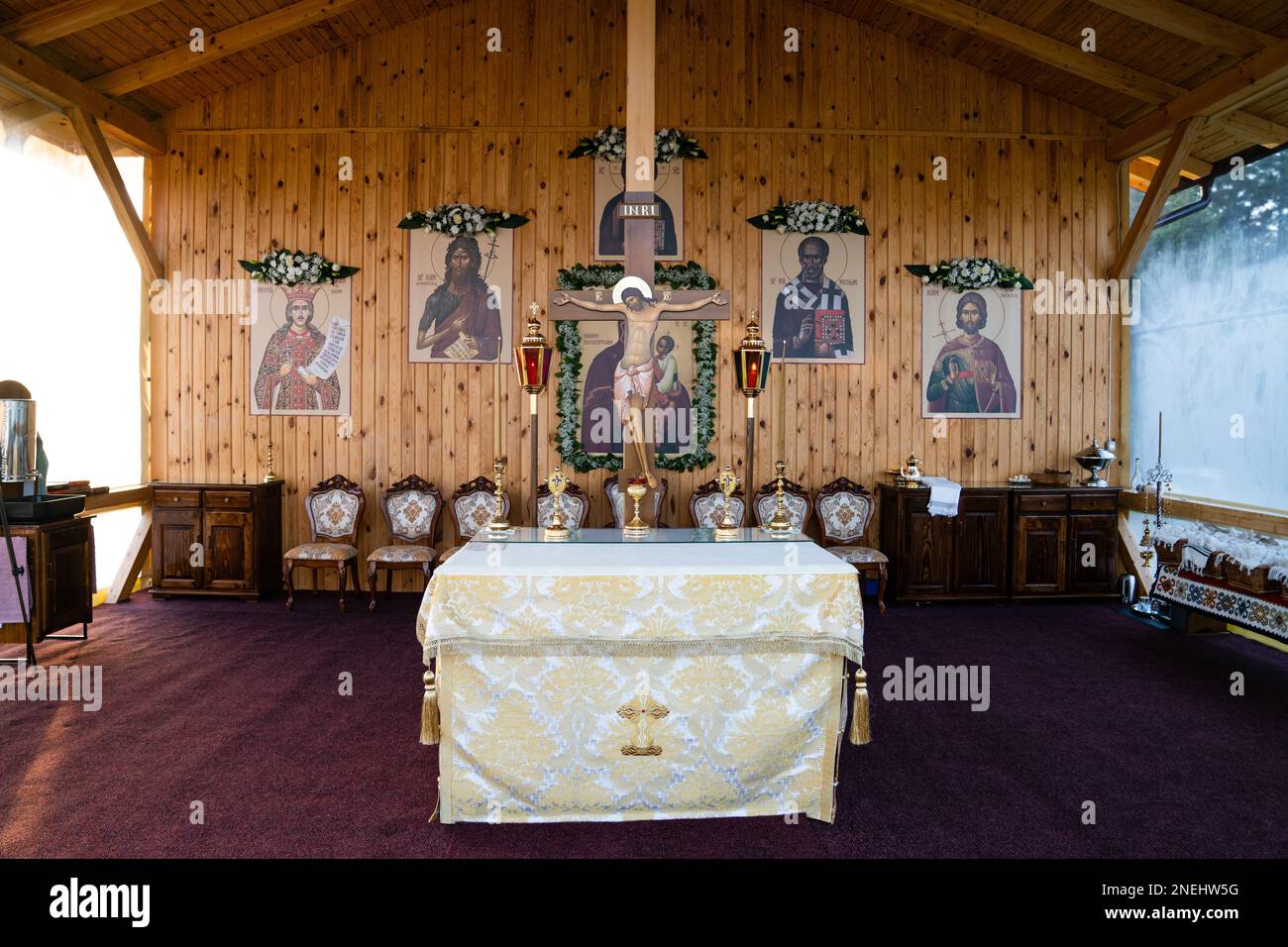 A communion table in front of a wall with religious icons in Roman ...