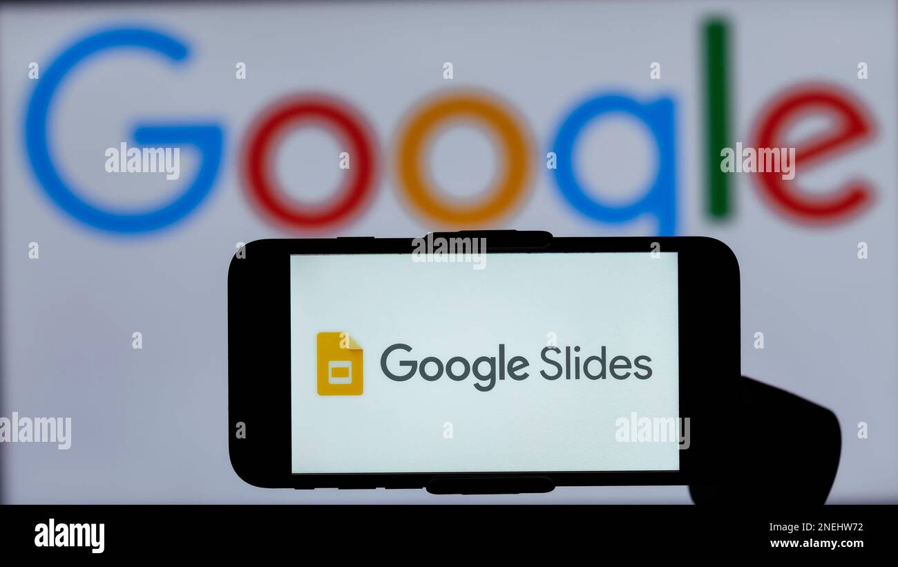 In this photo illustration, the logo of Google Slides is seen displayed ...
