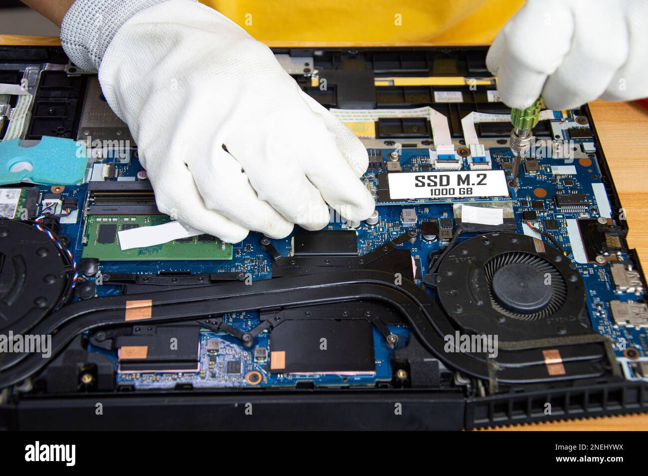 Top view of mechanic repairing computer, installing M.2 SSD Stock Photo ...