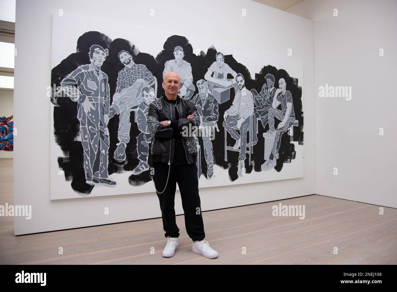 Artist, Eric Haze poses in front of his artwork during the exhibition ...