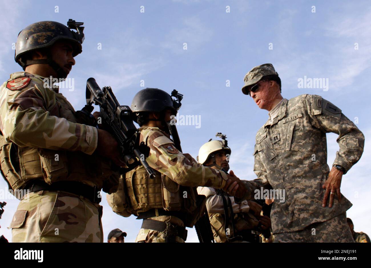 U.S. Army Capt. Sam Brown, right, shakes hands with Iraqi Special ...