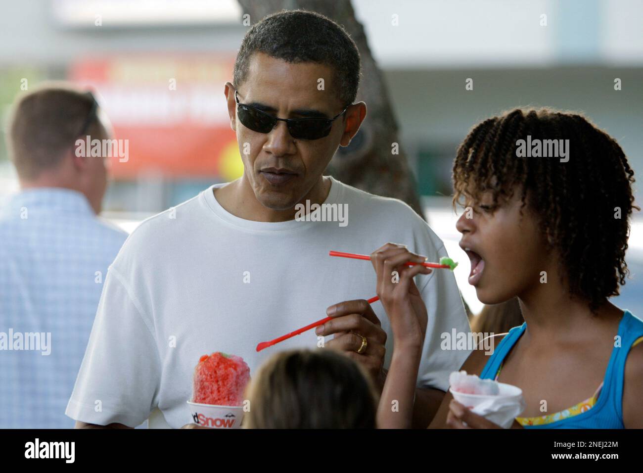 President Barack Obama enjoys shave ice with his daughter Malia Obama ...