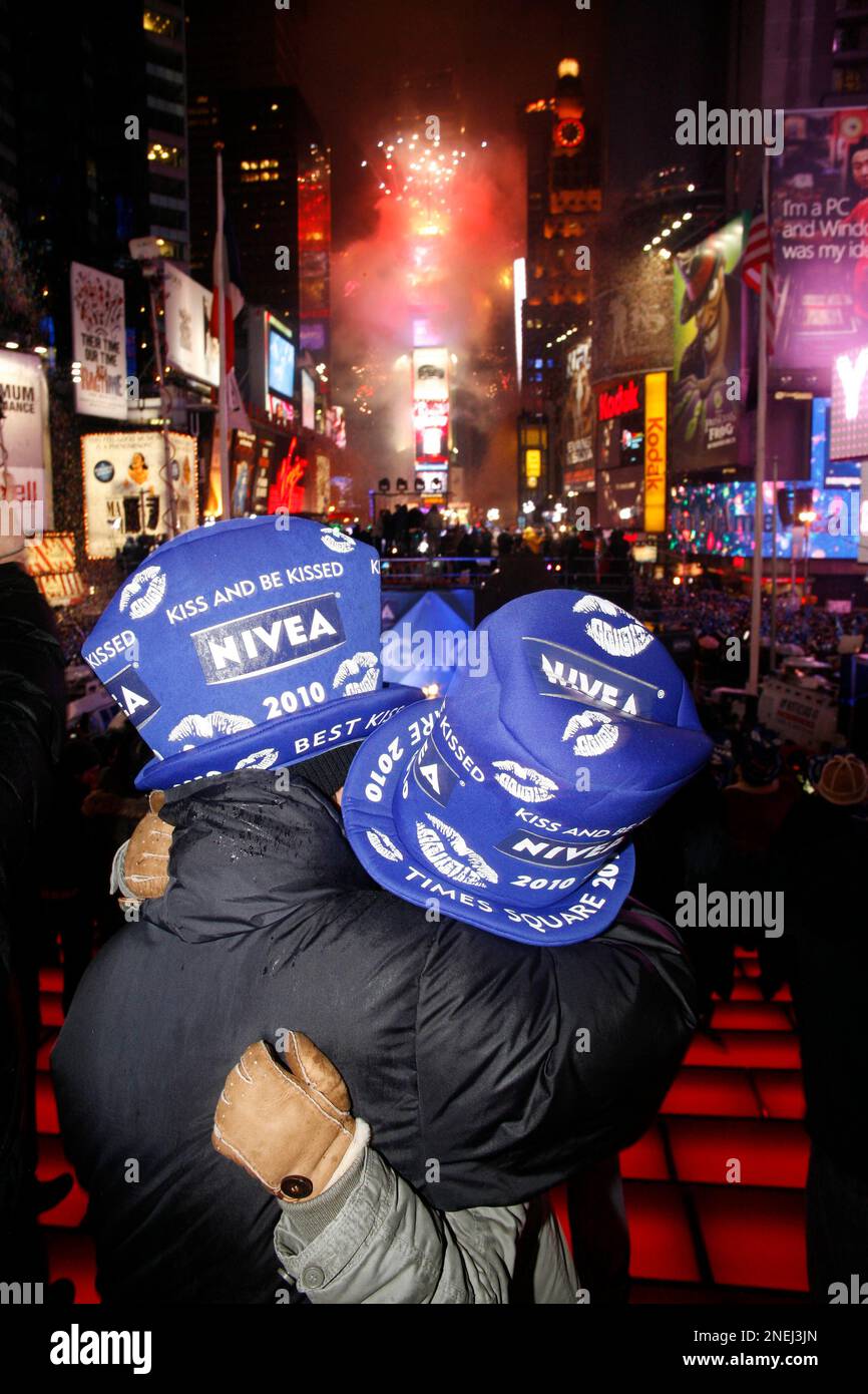 A couple kisses at midnight during New Year's Eve festivities in Times ...