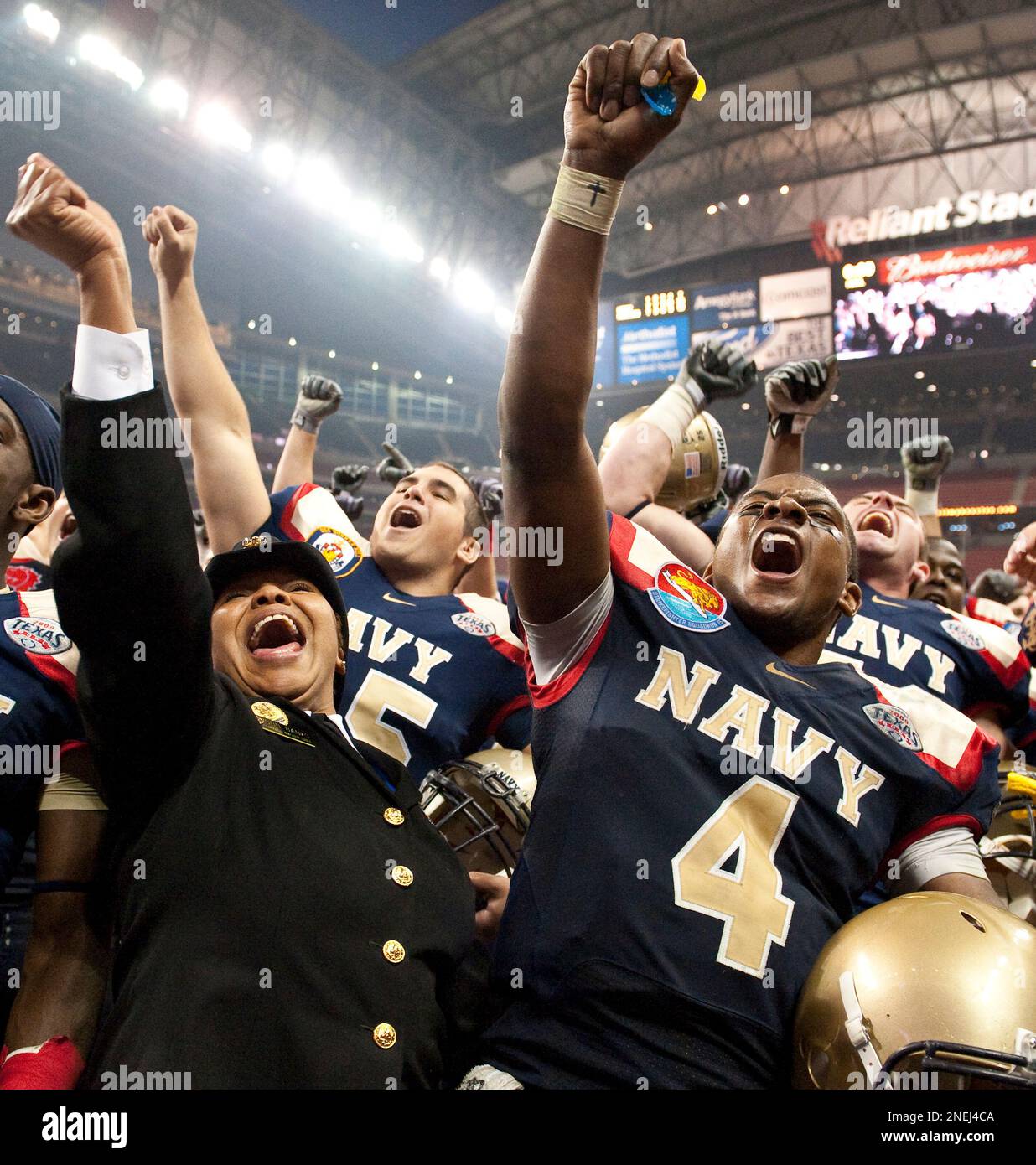 Navy quarterback Ricky Dobbs (4) celebrates with Vonn Banks, left ...