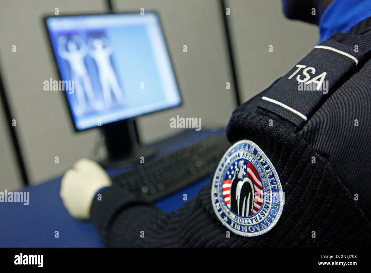 A Transportation Security Administration officer views a full-body scan ...