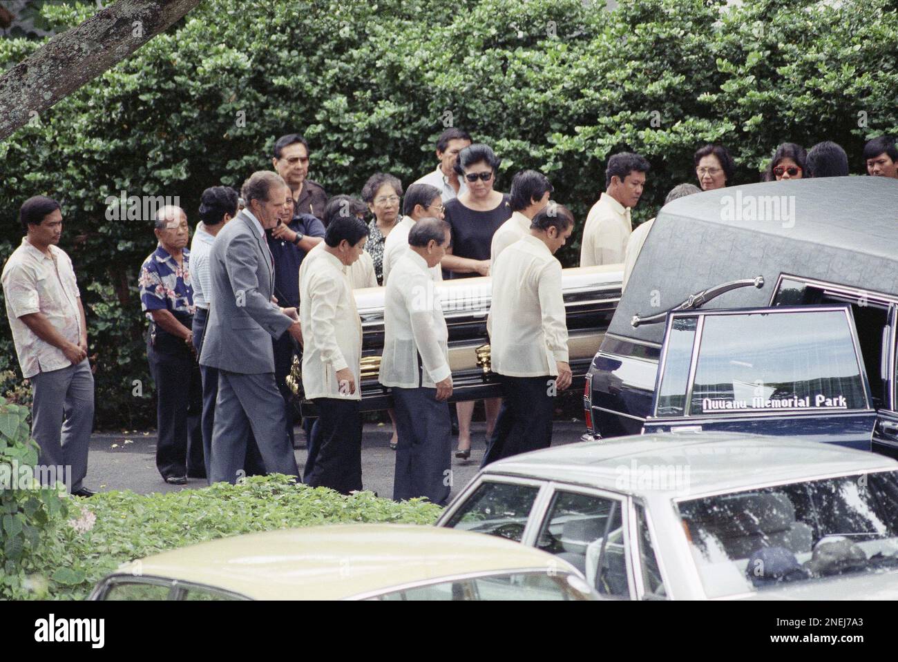 Imelda Marcos, center rear, watches as pallbearers carry the casket ...