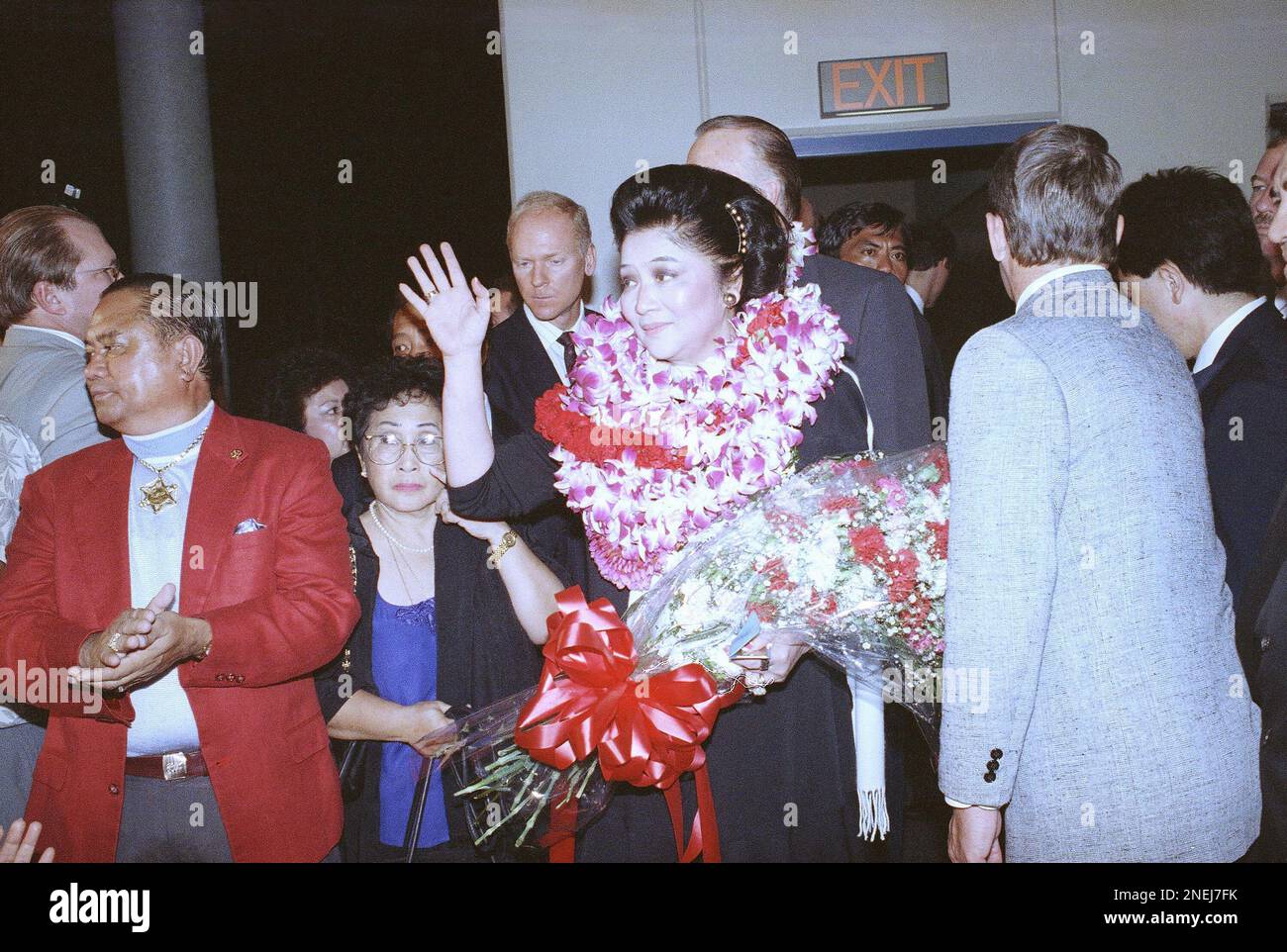 Philippine first lady Imelda Marcos, carrying roses and bedecked with ...