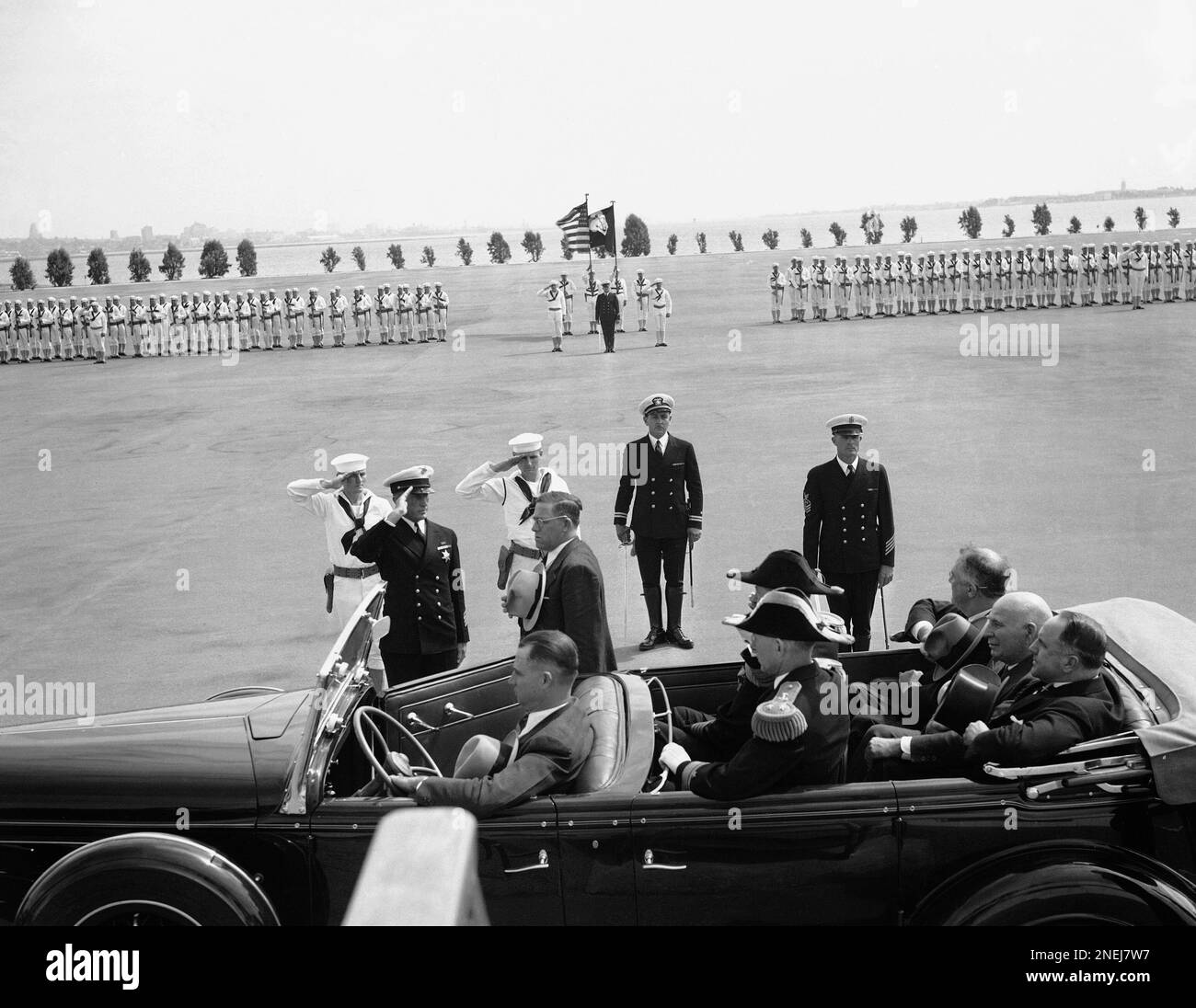 President Franklin Roosevelt is shown receiving a salute from officers ...