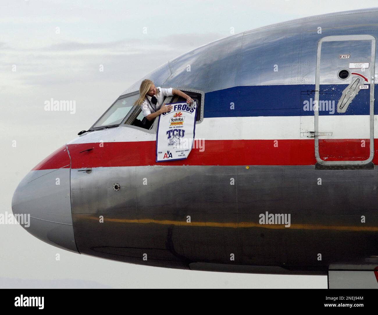 American Airlines captain Kelli Hughes hangs a banner out the window of ...