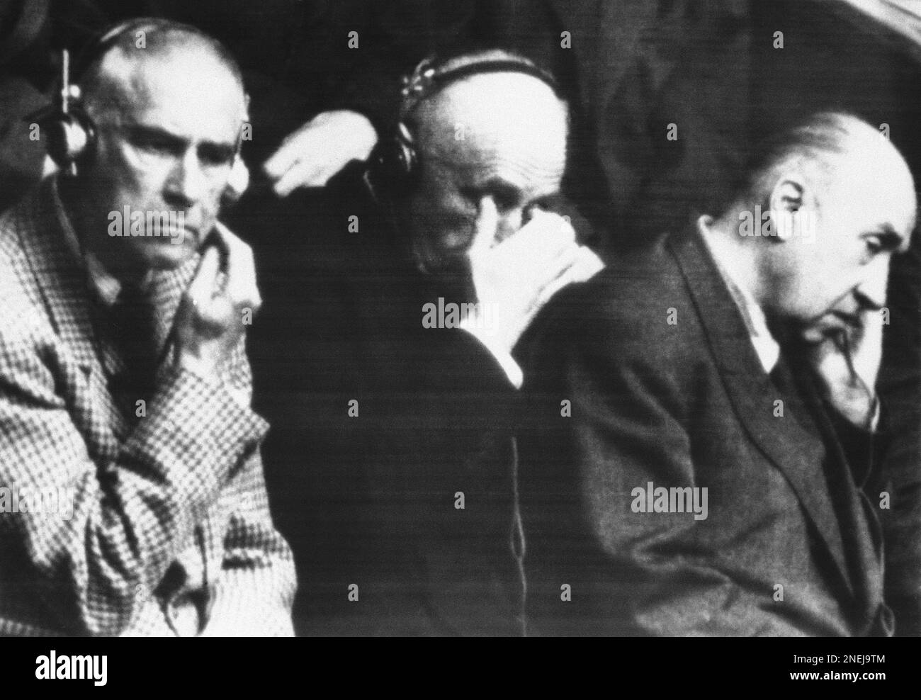 Wilhelm Frick scratches his jaw; Julius Streicher rubs his eyes and ...