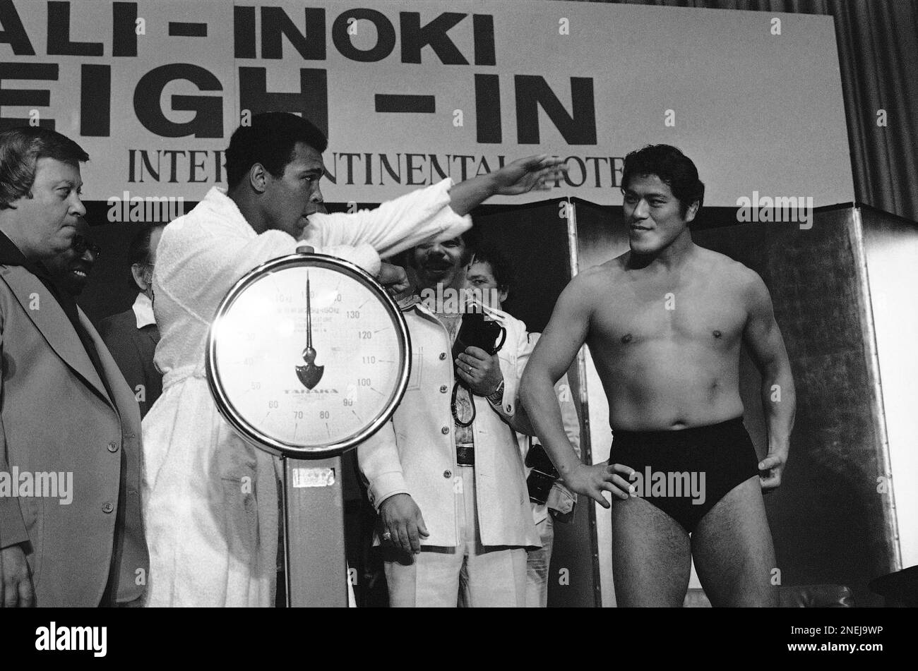 World heavyweight boxing champion Muhammad Ali, standing on scale, left ...