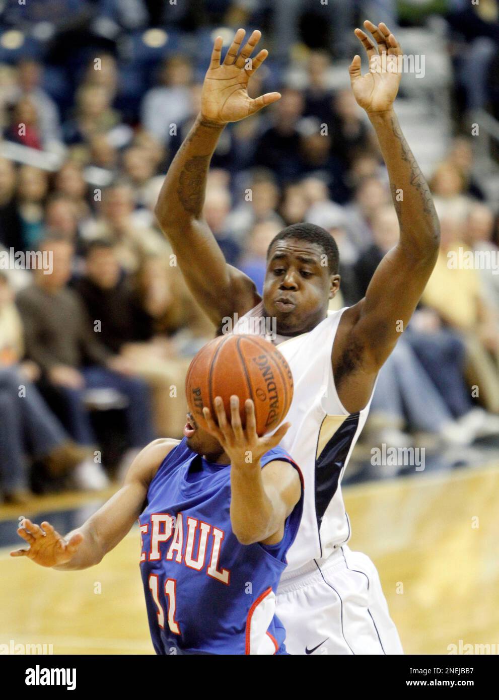 Pittsburgh's Dante Taylor, top, goes for the block as DePaul's Jeremiah ...