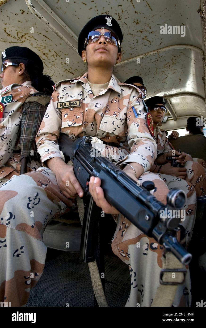 Pakistan's female paramilitary soldiers observe an area, where Shiite ...