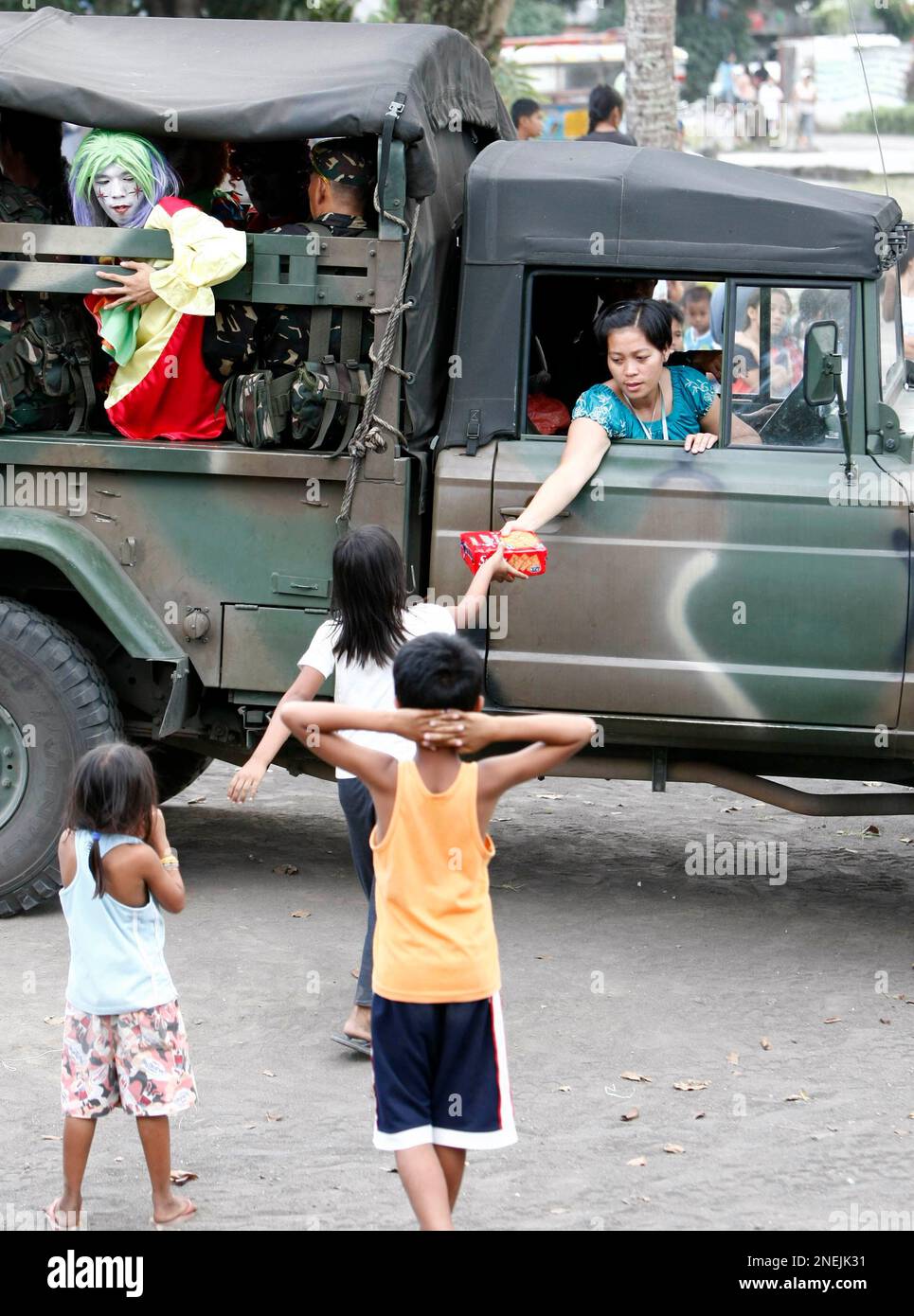 A soldier from the Philippine Army's 901st Brigade hands biscuits to ...