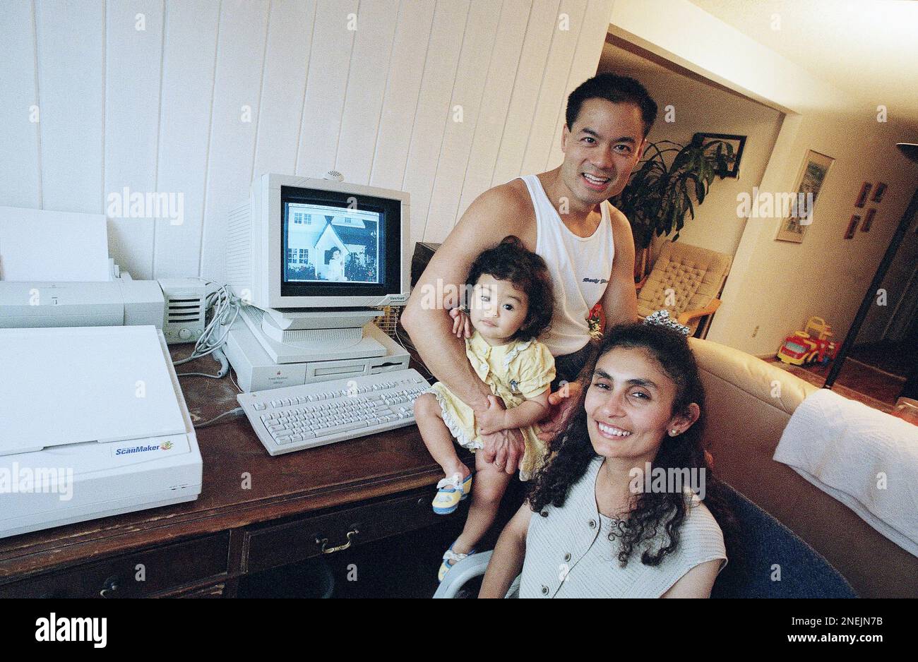 Joseph Chiang sits at the family computer with his wife Lilian Hanna ...