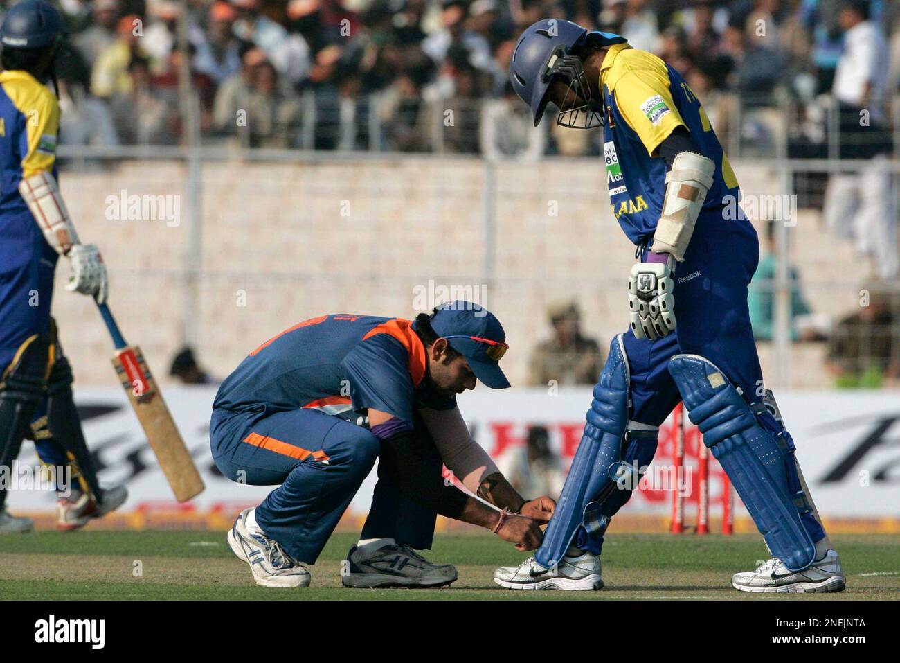 India's Virat Kohli, on ground, ties a knot for Sri Lanka's Tilakaratne ...