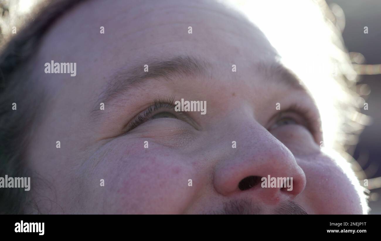 Spiritual young man closeup eyes looking at sky smiling feeling ...