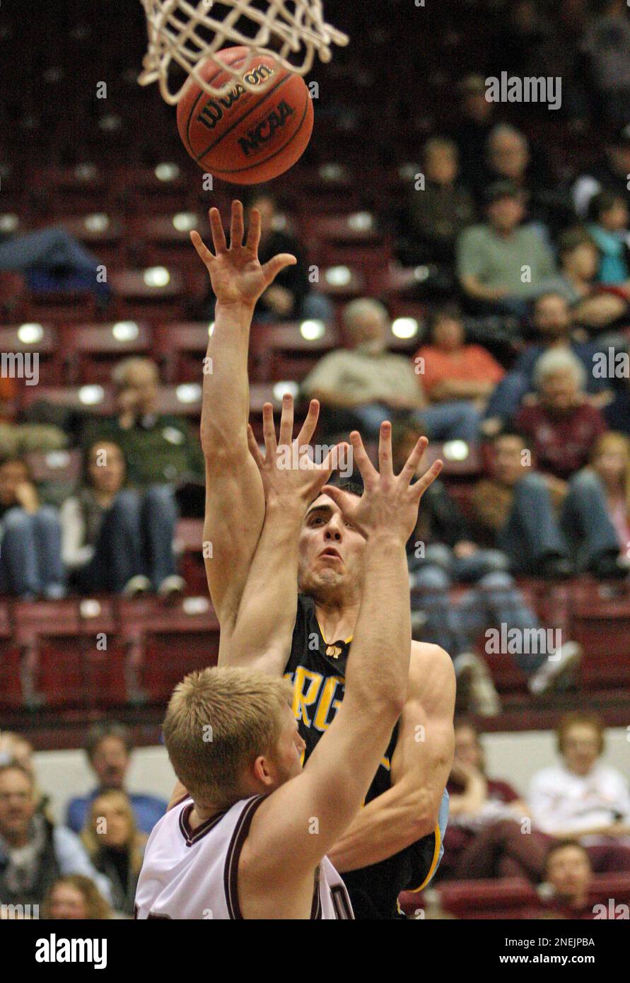 Great Falls guard Lukas Hambsch(10) shoots in front of Montana forward ...