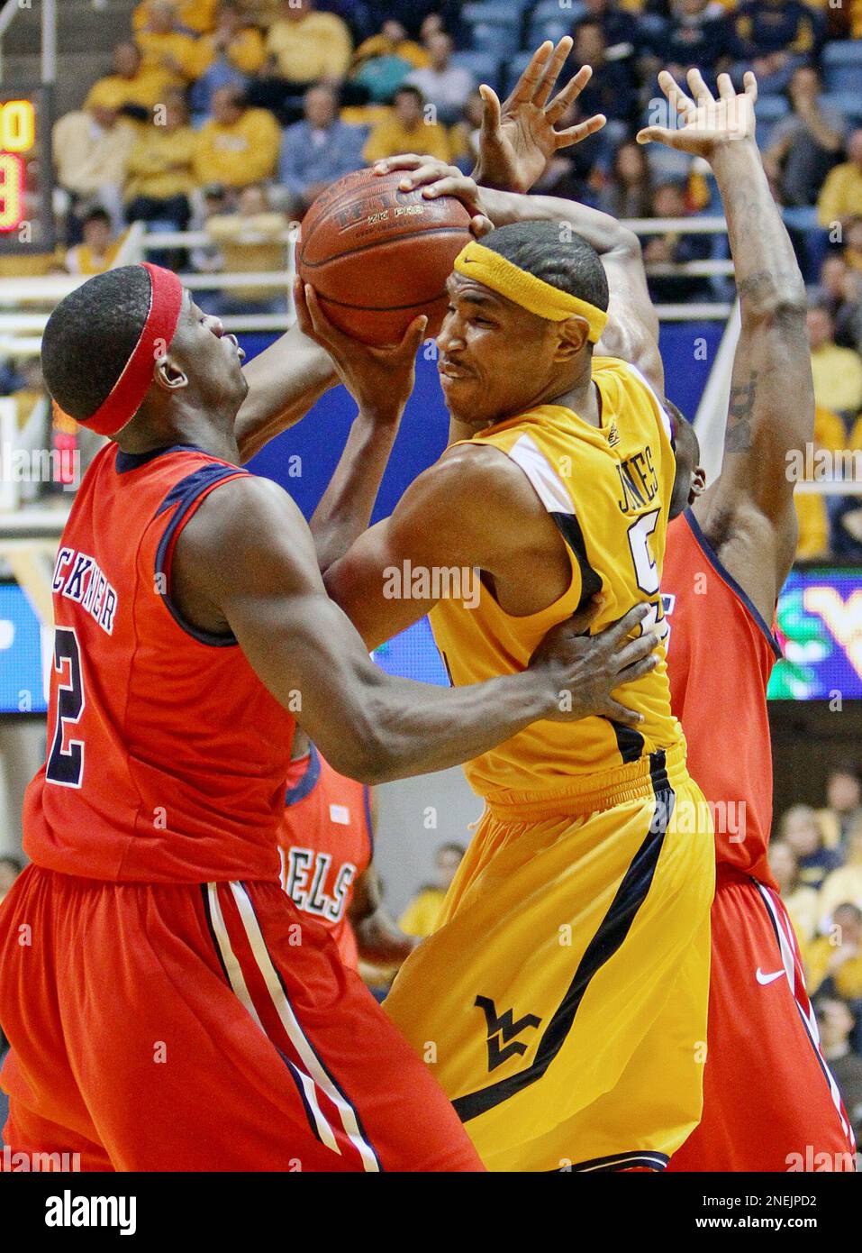 West Virginia's Kevin Jones, center, is guarded by Mississippi's ...