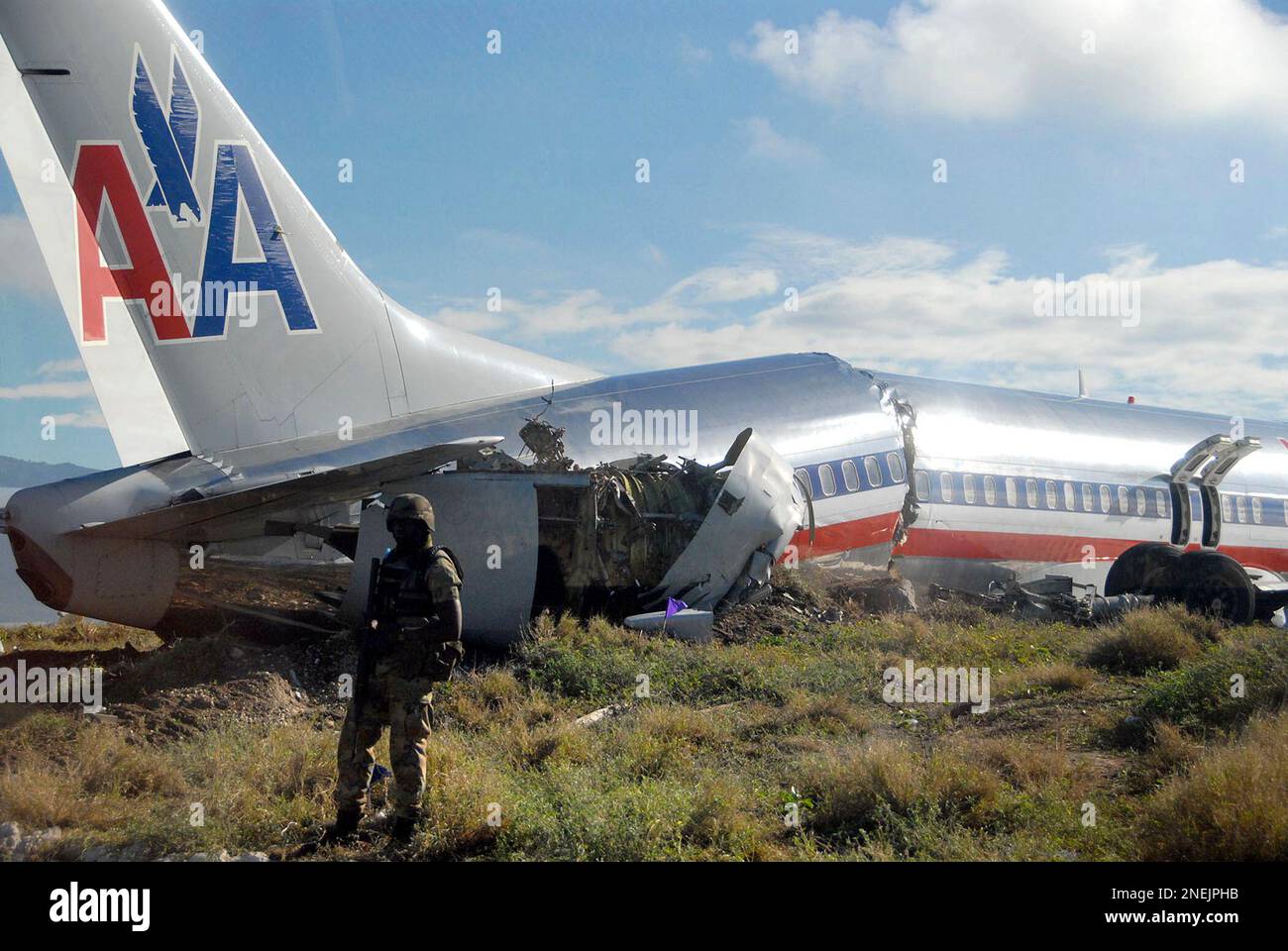 A soldier guards the cracked fuselage of American Airlines flight AA331 ...