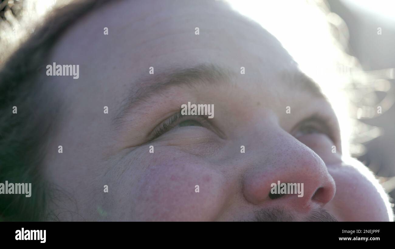 Spiritual young man closeup eyes looking at sky smiling feeling ...