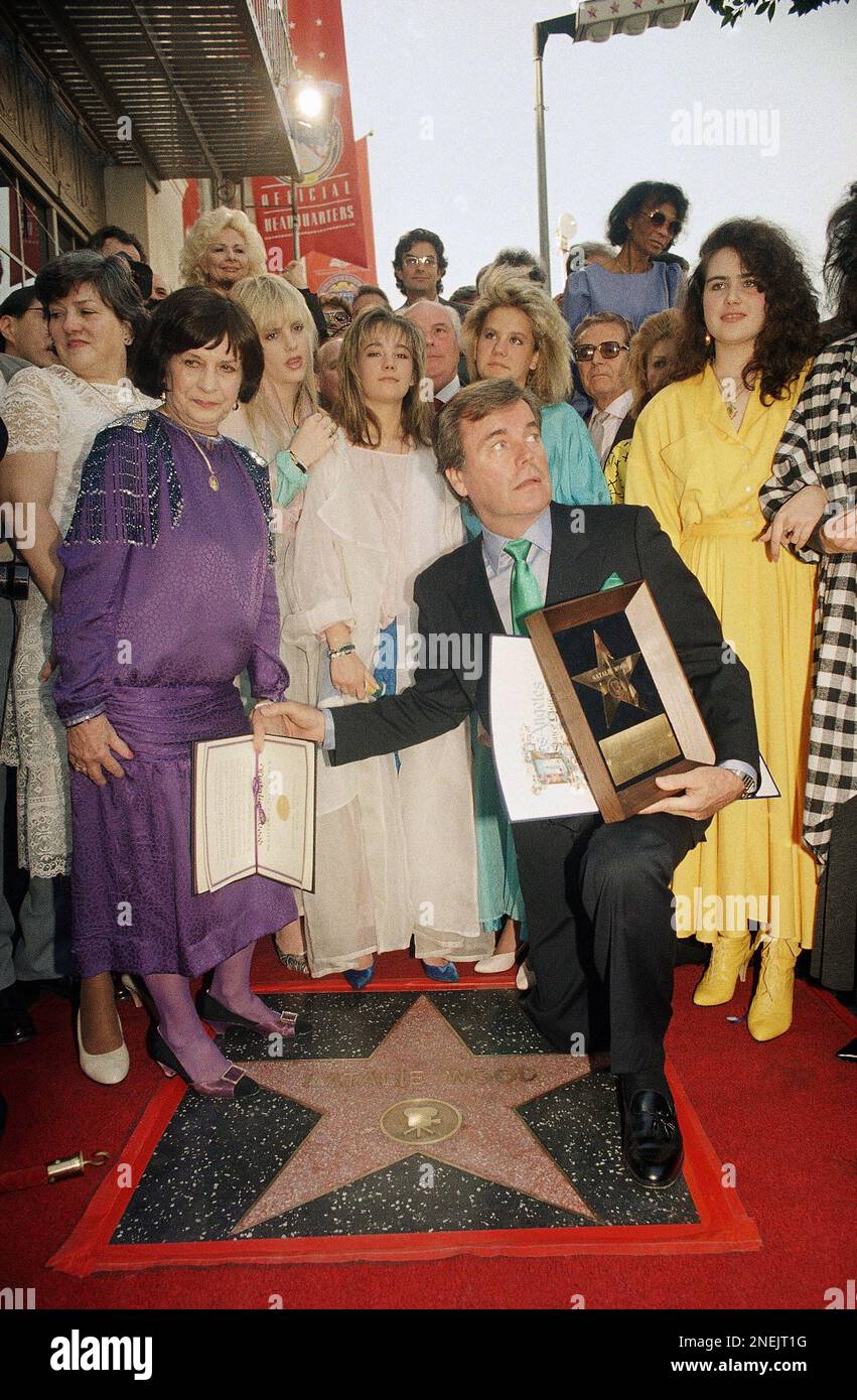 Actor Robert Wagner holds the hand of Maria Gurdin, mother of the late ...