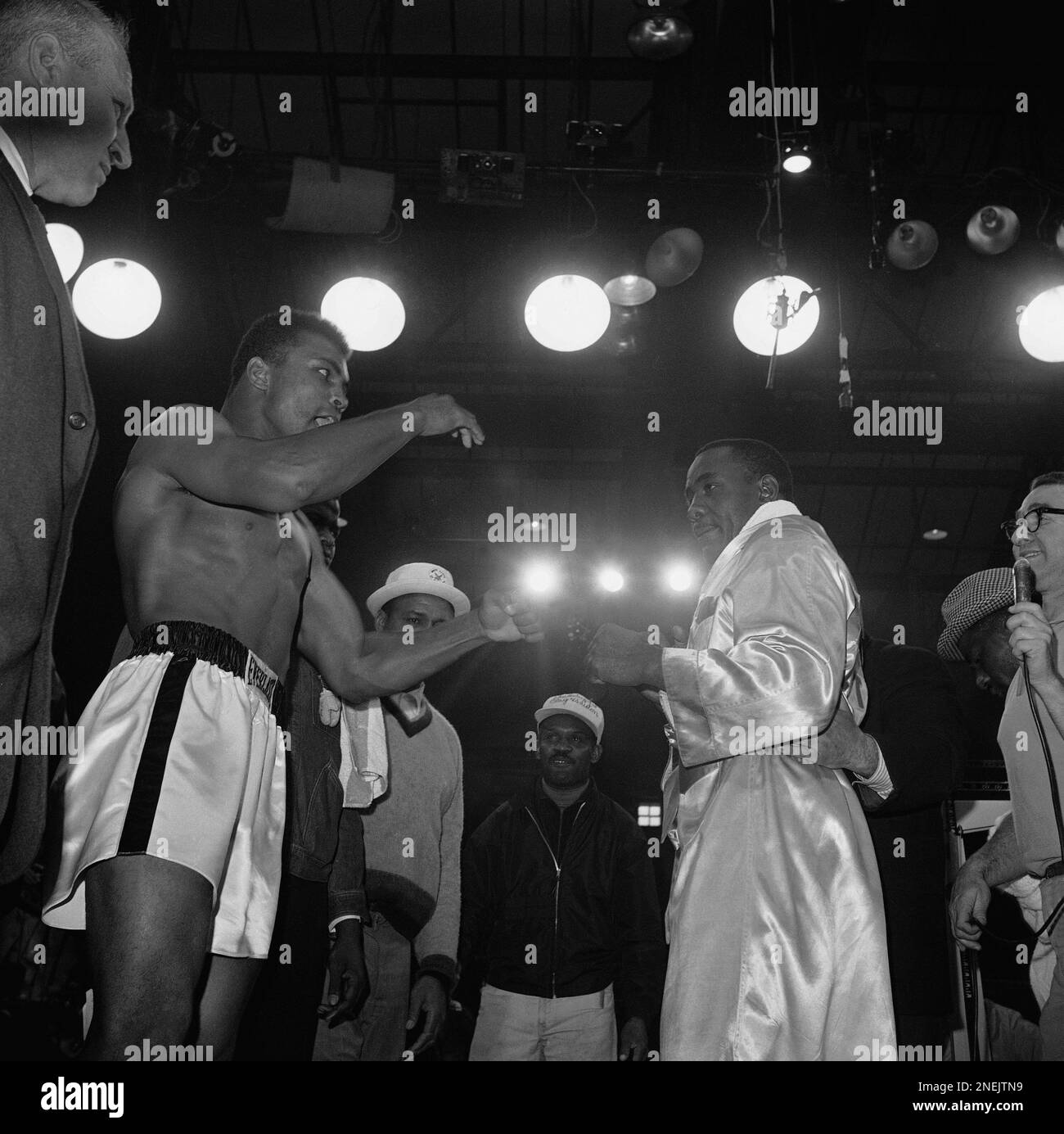 Heavyweight champion Muhammad Ali, left, does a bit of heavy clowning ...