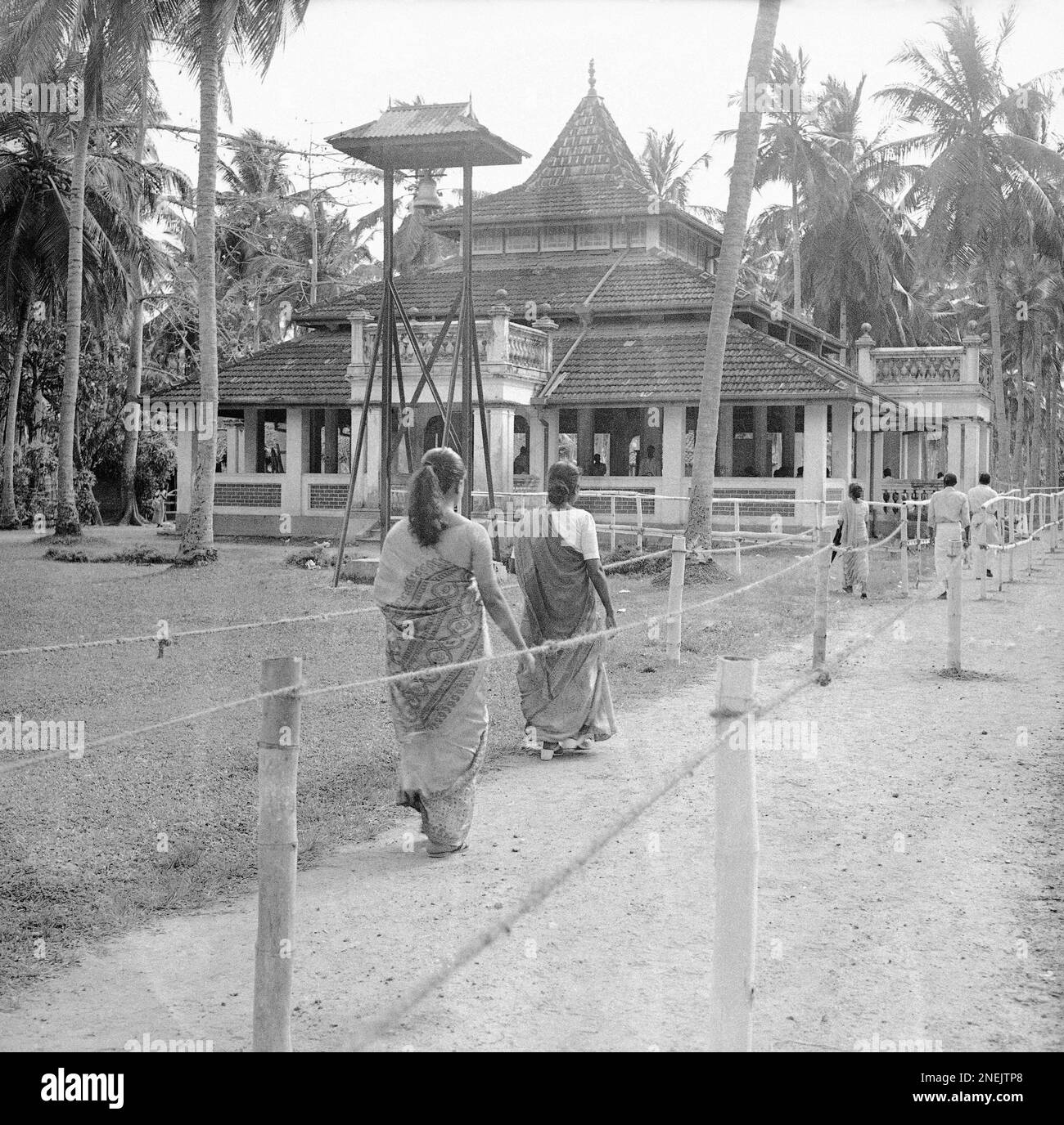 Women going to vote in a Buddhist preaching hall (part of a temple ...