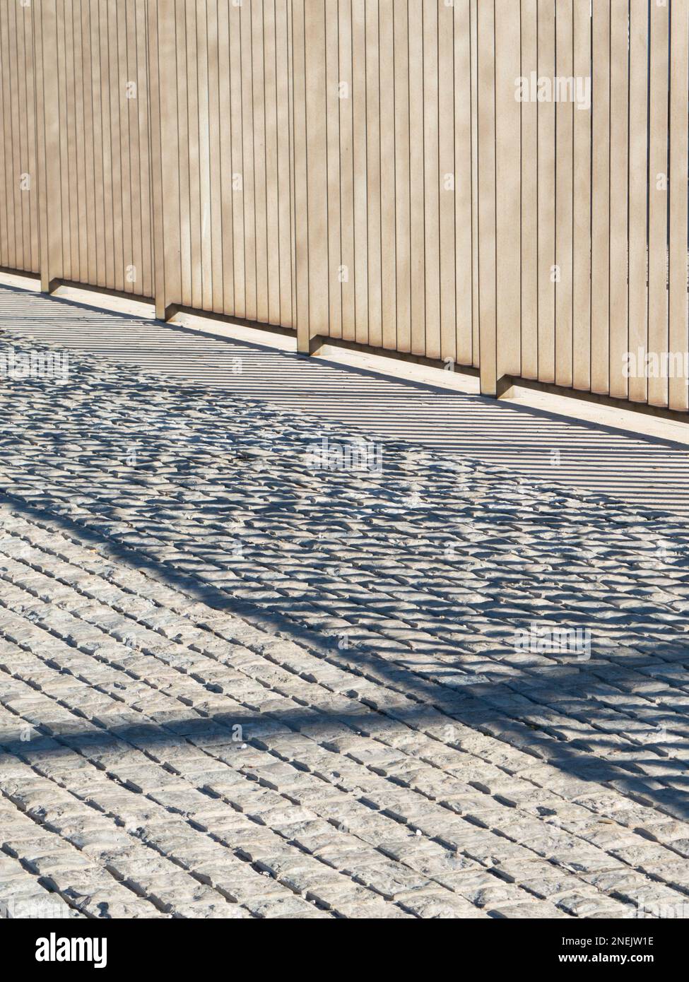 Shadow of a fence on the stone sidewalk, geometric pavement Stock Photo ...