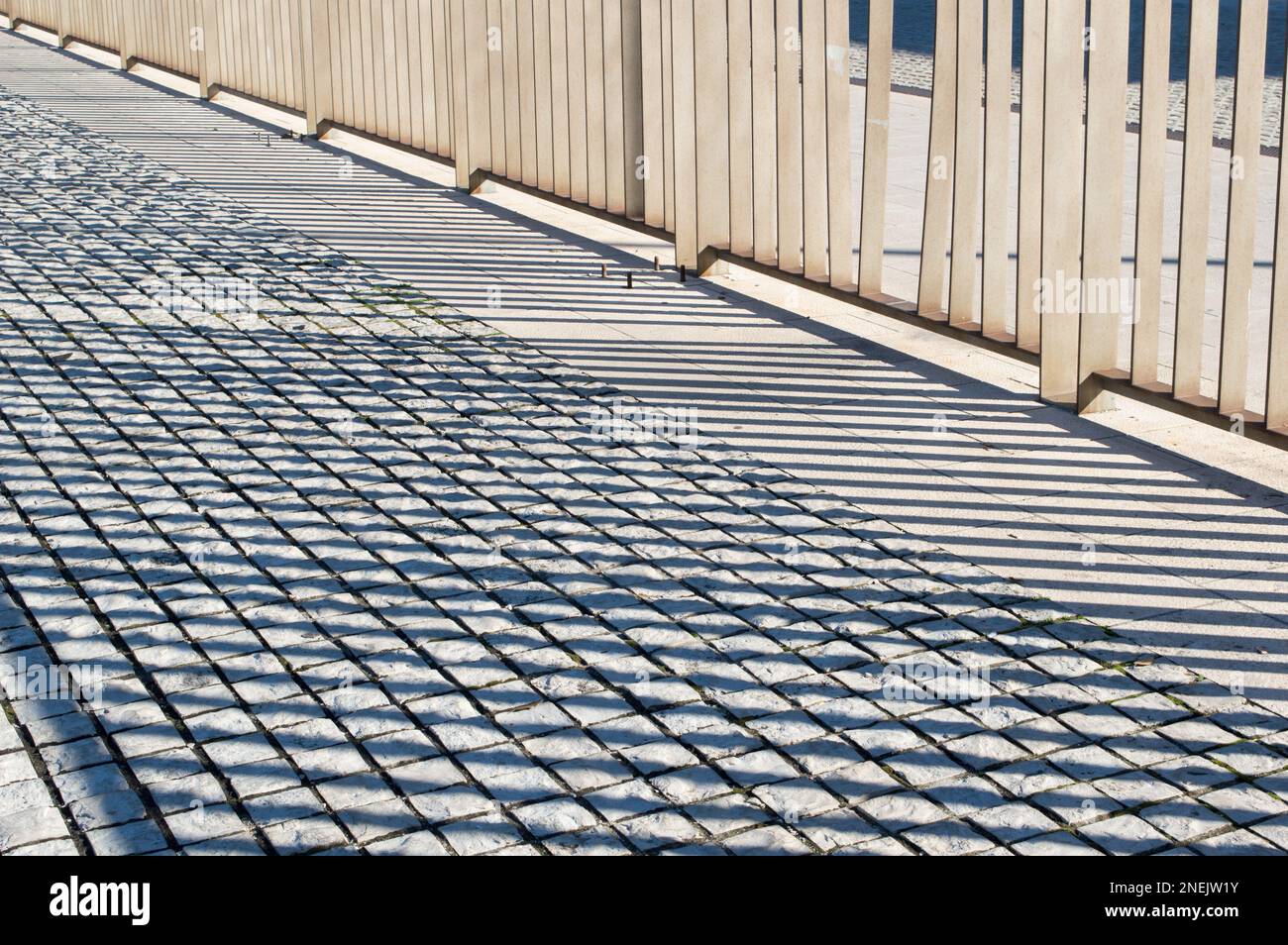 Shadow of a fence on the stone sidewalk, geometric pavement Stock Photo ...