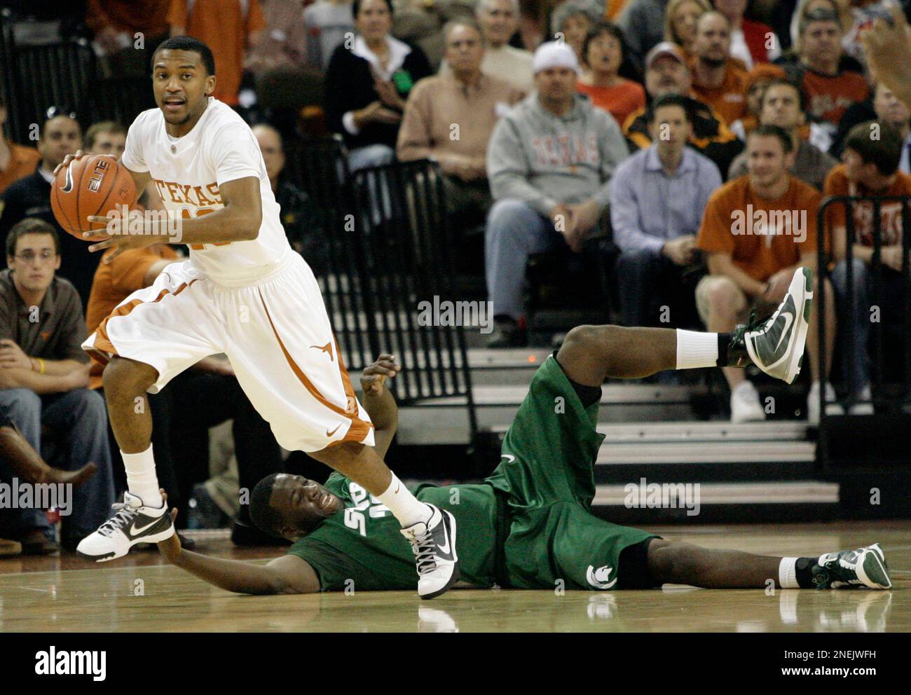 Texas guard Jai Lucas, left, leaves Michigan State forward Draymond ...