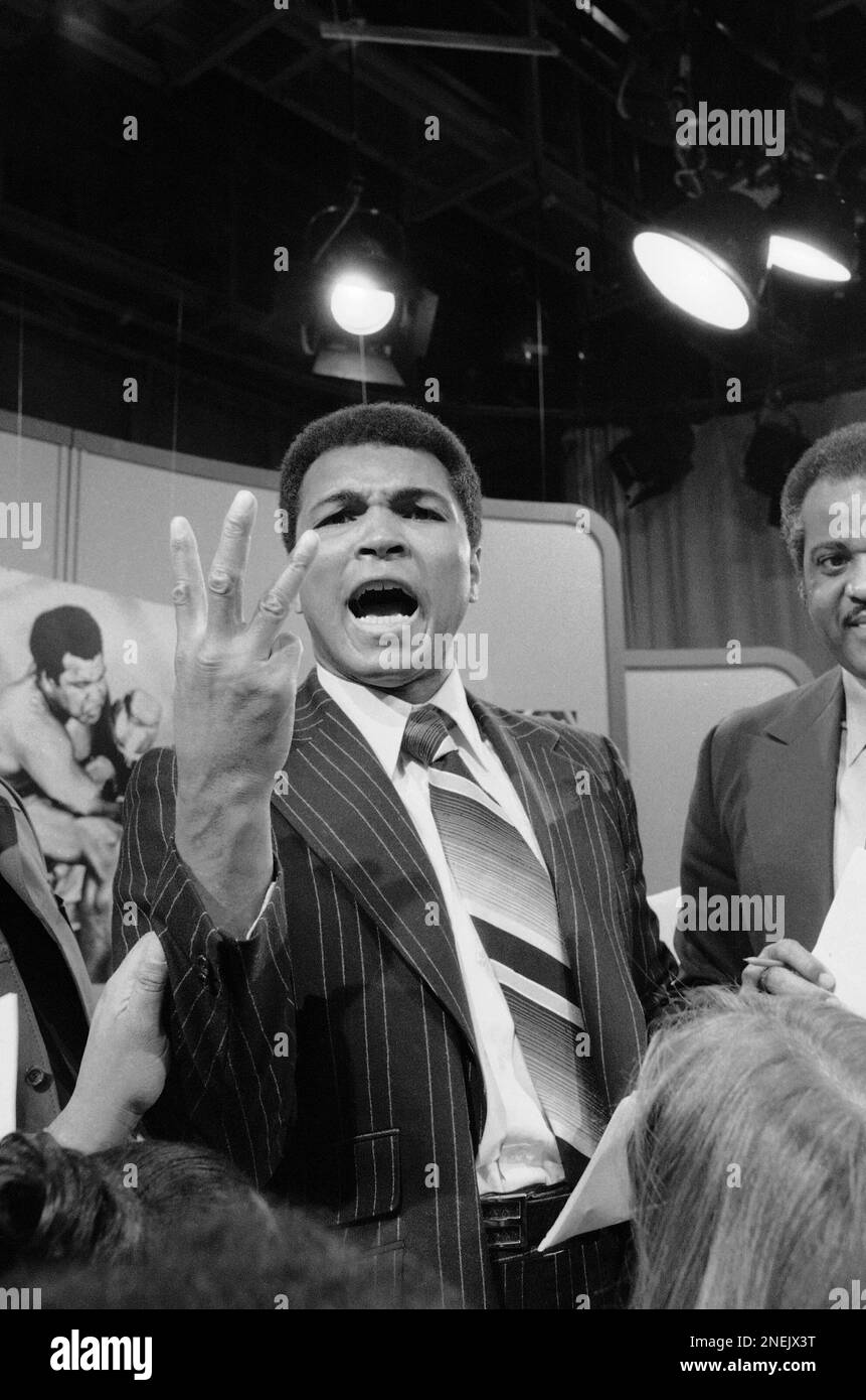 Former heavyweight champ Muhammad Ali holds up fingers to emphasize his ...