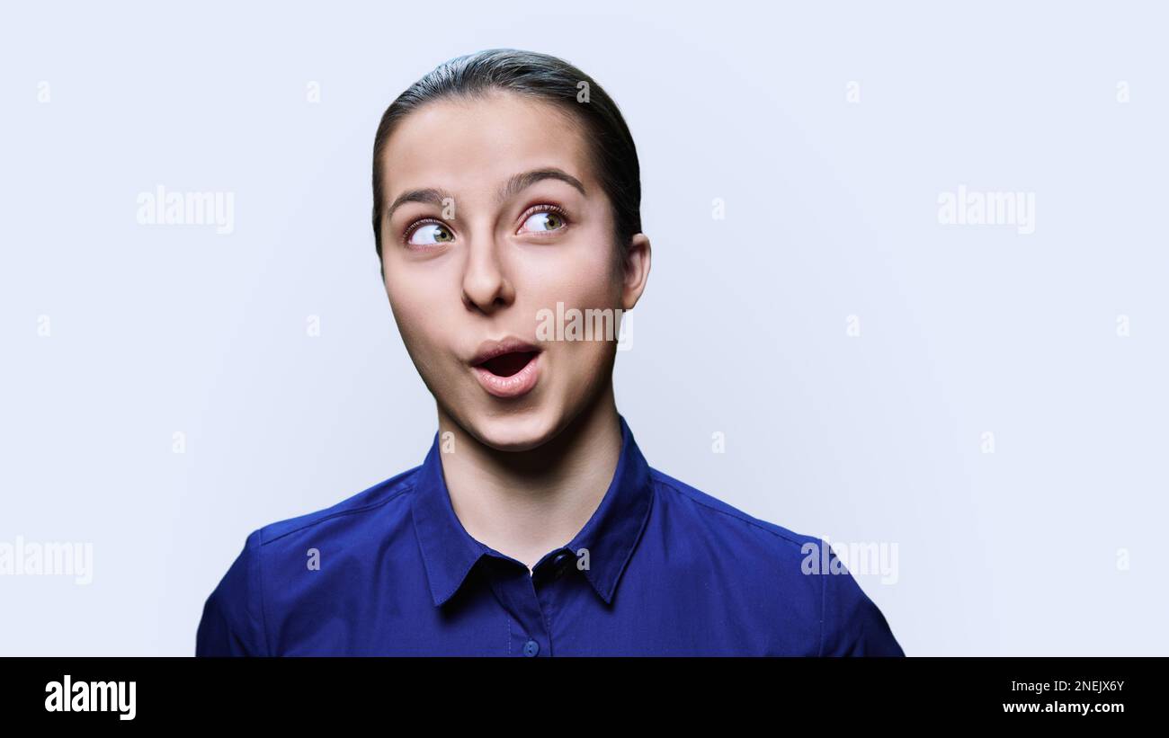 Close-up of confused young female on white studio background Stock ...