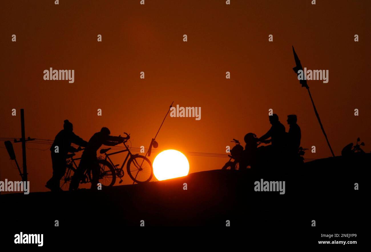 Hindu devotees walk at Sangam in Allahabad, India, Tuesday, Dec. 22 ...
